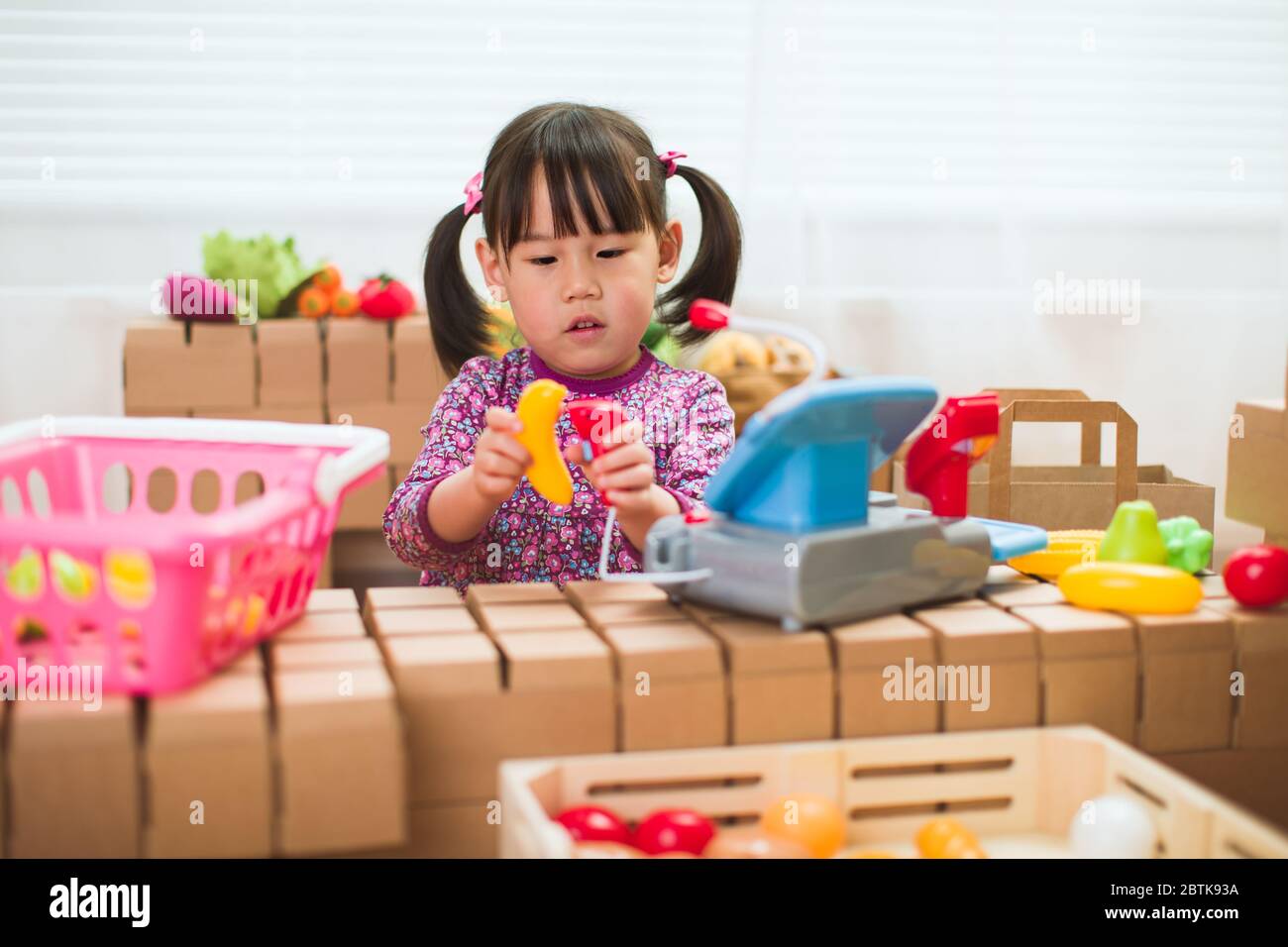 toddler girl pretend play sweet shop keeper at home Stock Photo - Alamy
