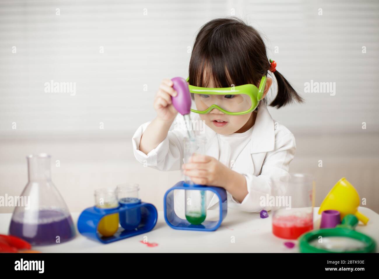 toddler girl pretend play scientist role for homeschooling Stock Photo ...