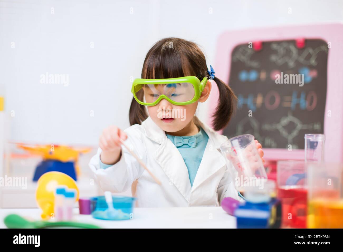 toddler girl pretend play scientist role for homeschooling Stock Photo ...