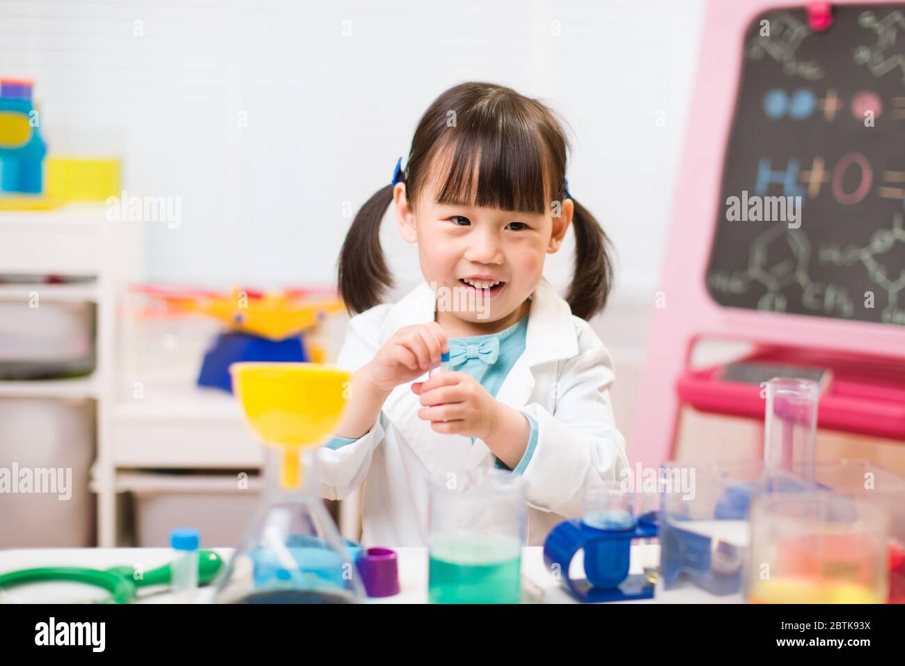 toddler girl pretend play scientist role for homeschooling Stock Photo ...