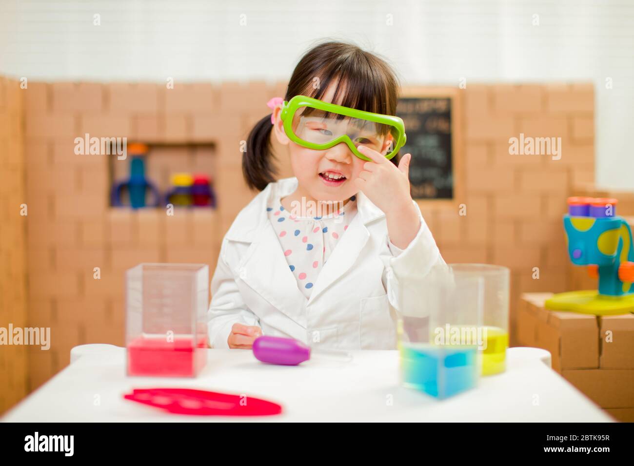 toddler girl pretend play scientist role for homeschooling Stock Photo ...