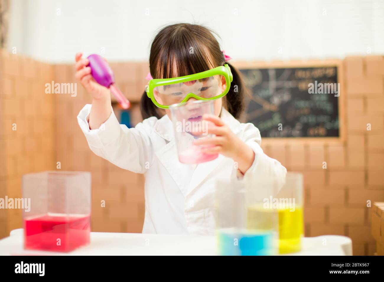 toddler girl pretend play scientist role for homeschooling Stock Photo ...
