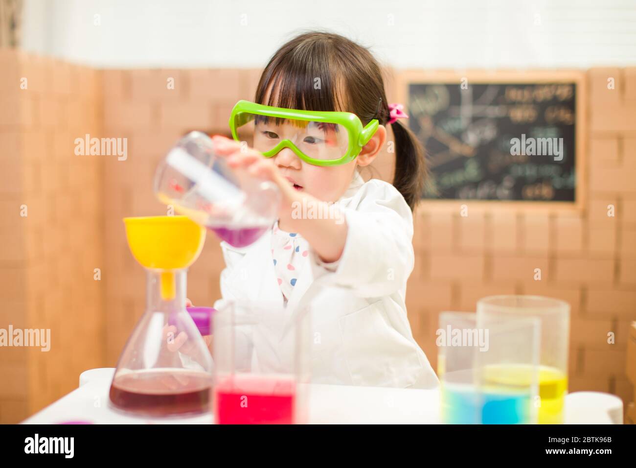 toddler girl pretend play scientist role for homeschooling Stock Photo ...