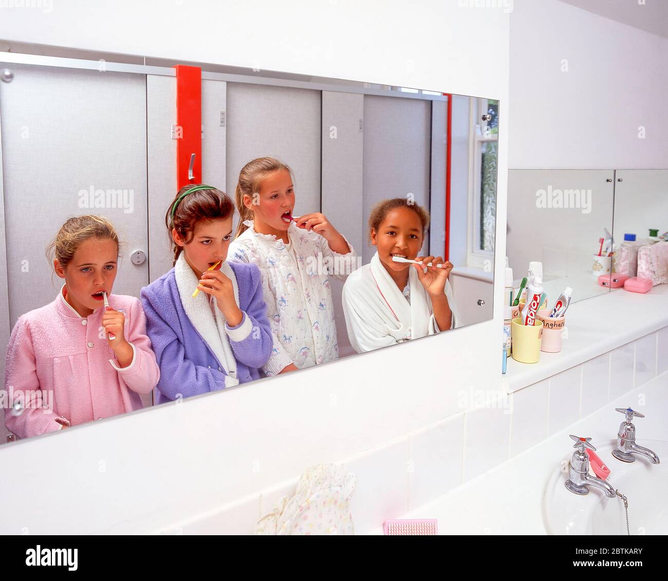 Girls brushing teeth at boarding school, Surrey, England, United ...