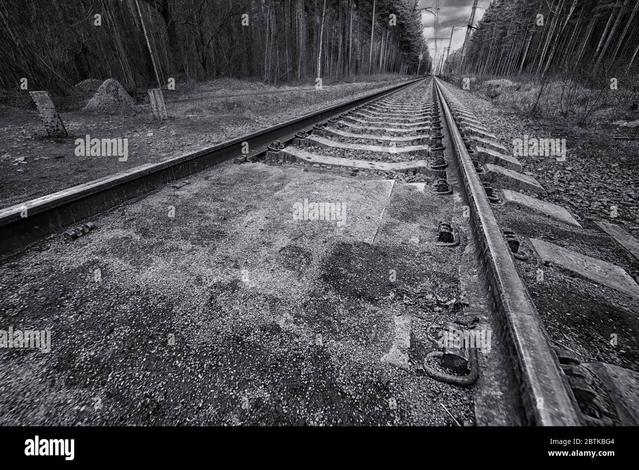 Endless rails. Wide angle view of long straight railroad. Black and ...
