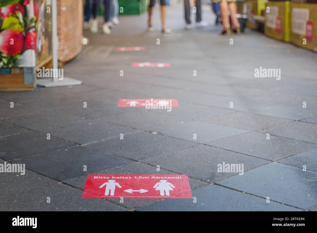 "Haltet 1.5m Abstand " mean "Keep 1.5 m distance"on red rectangular ...