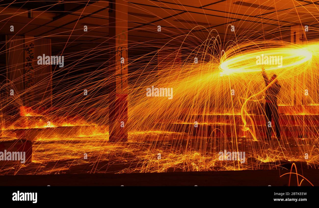 Steel wool spinning in a lost place Stock Photo - Alamy