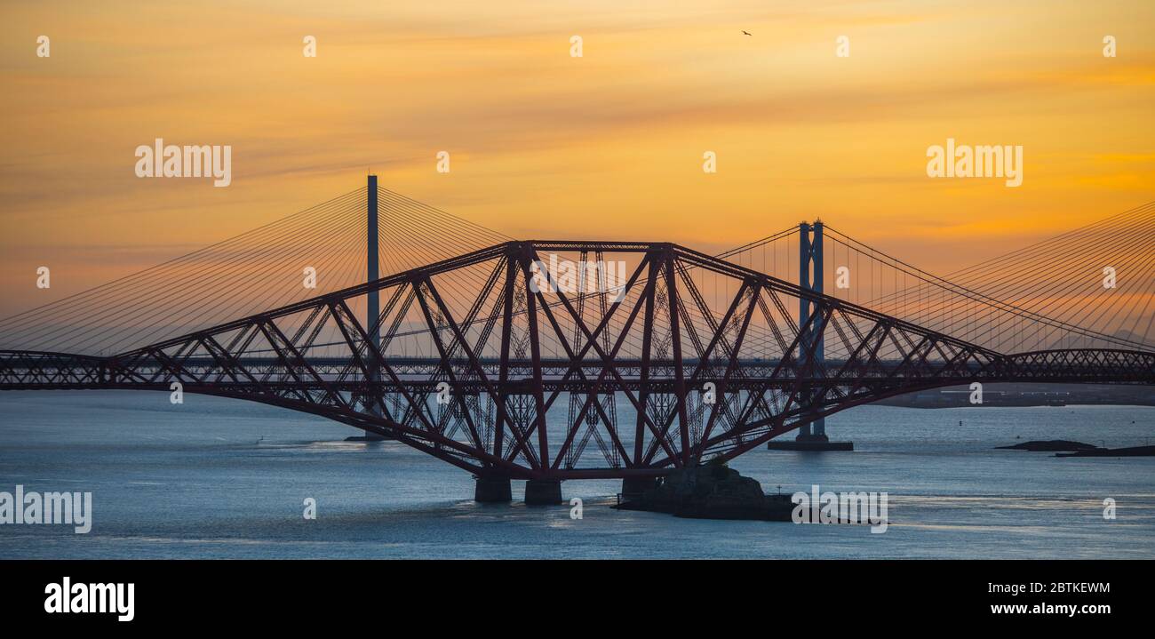South Queensferry, Scotland, UK A sunset dusk view of the three bridges ...