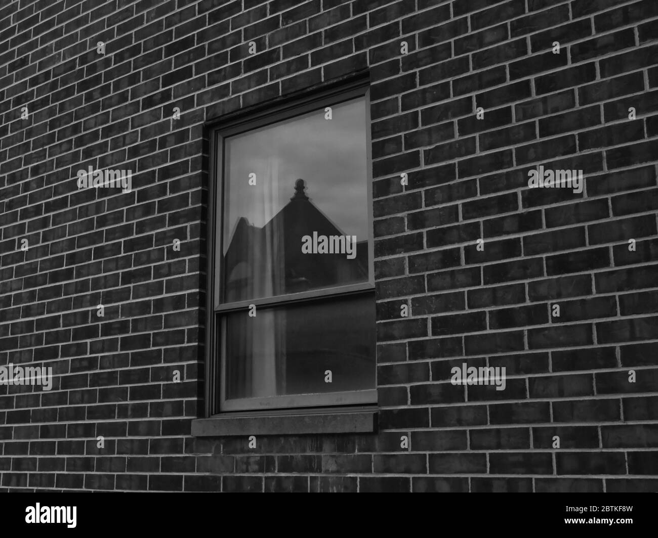 Black and white image of a window with a building reflection Stock ...