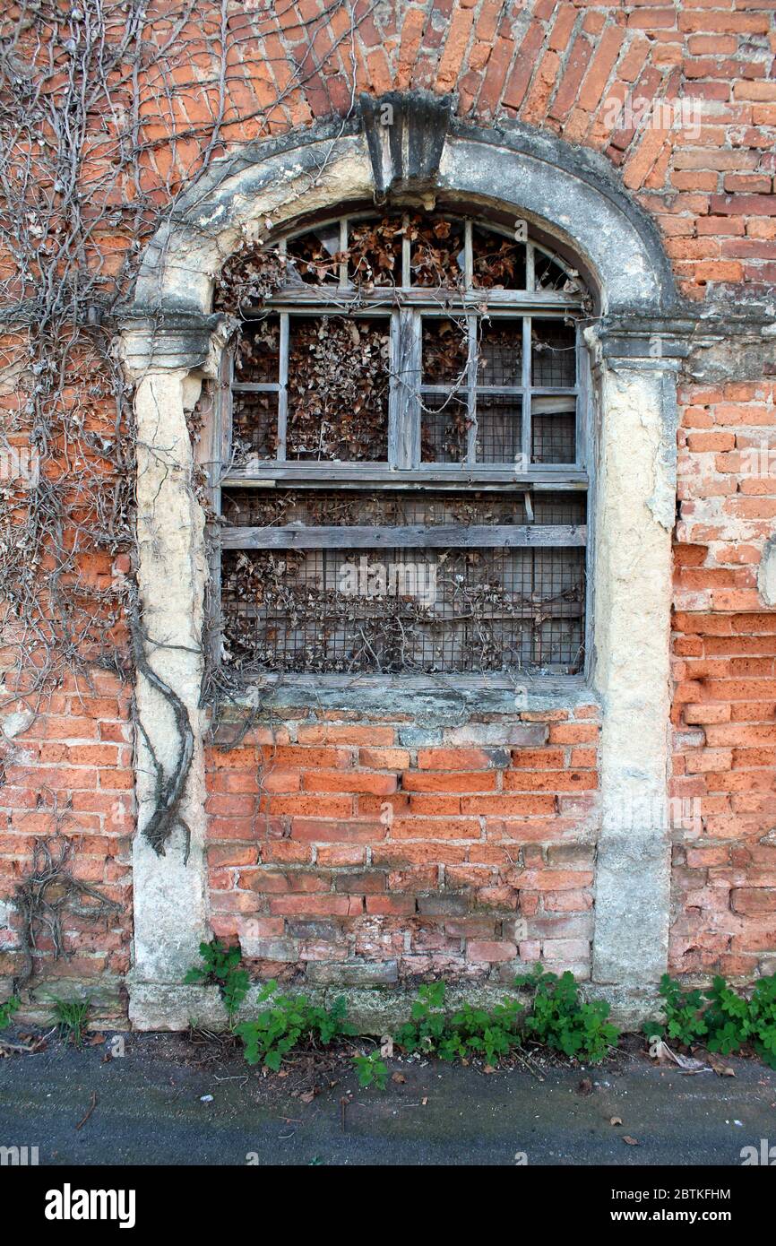 Closed and boarded creepy looking old venetian style red brick ... Closed and boarded creepy looking old venetian style red brick ...