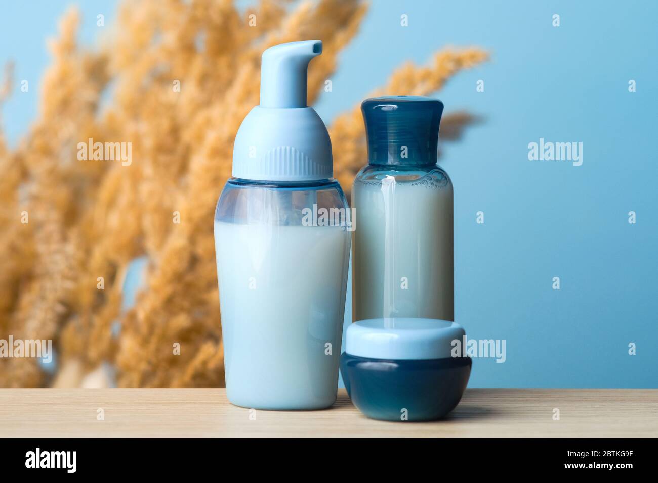 Blue cosmetic bottles set and jar with natural organic cream. Beauty ...