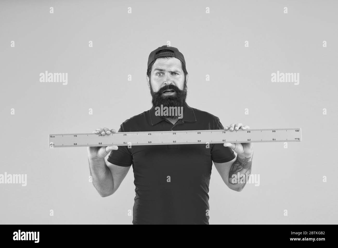 Shop assistant. Perfect size. Bearded man with big measuring instrument ...
