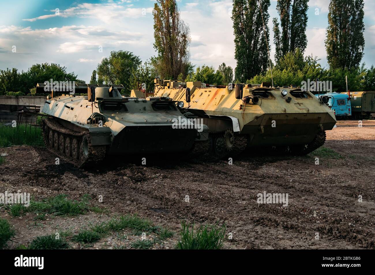 Old Russian armored vehicles on sunset background at military base ...