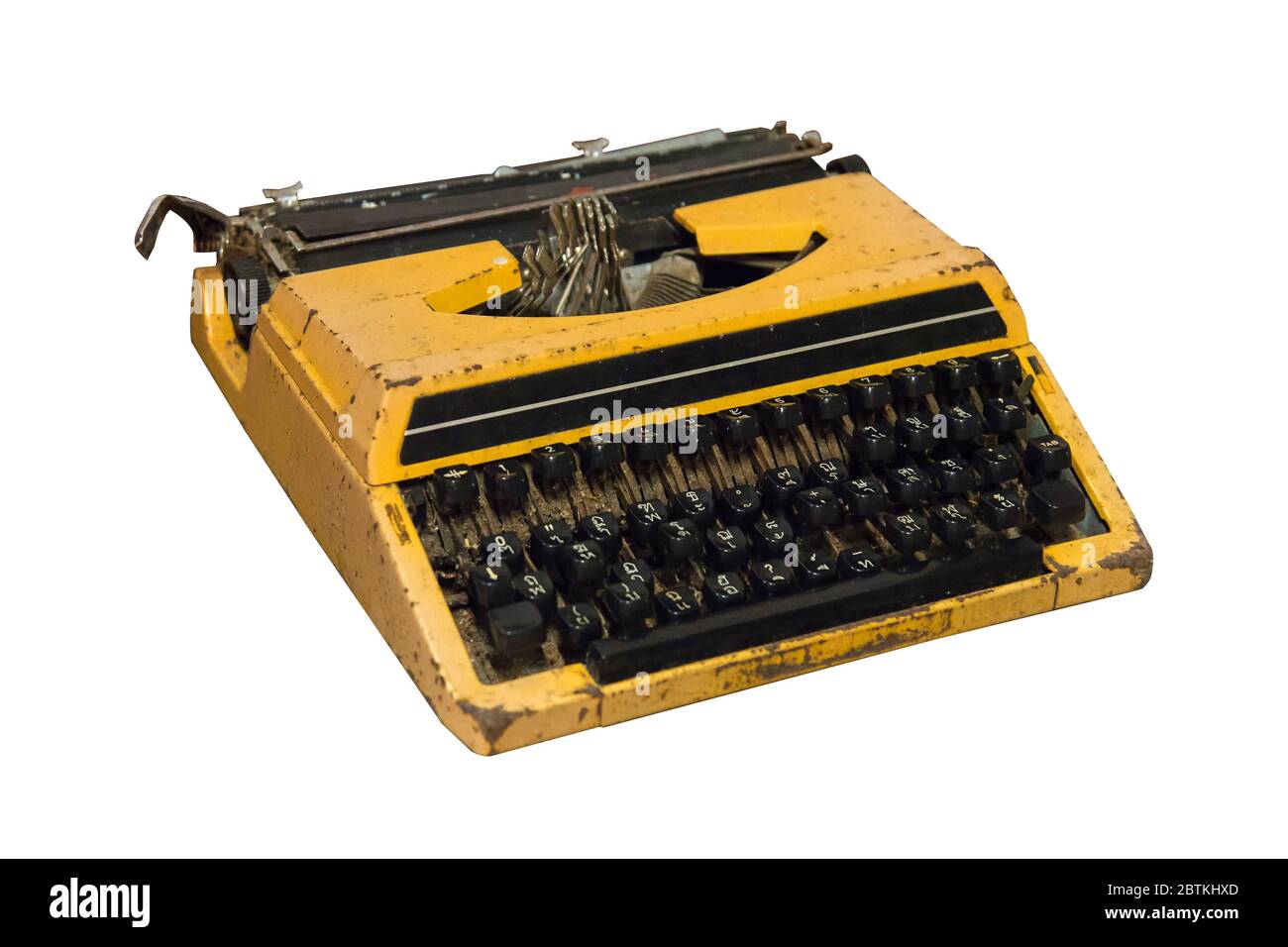 Rusty old vintage yellow typewriter isolated on white background, work ...