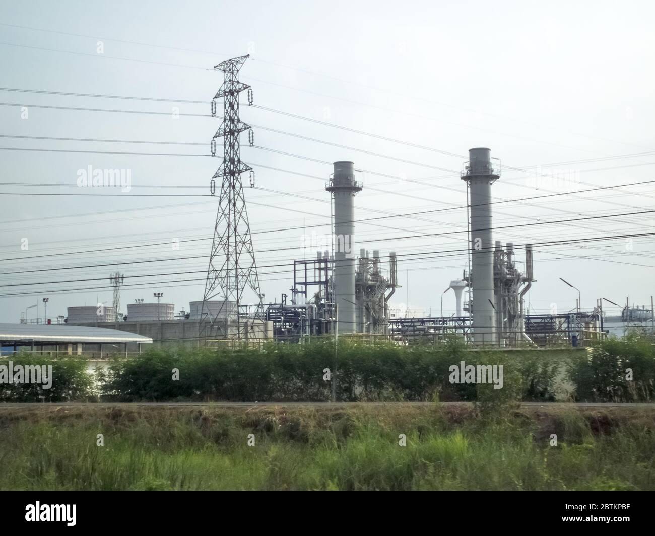 Factory with high voltage towers Stock Photo - Alamy