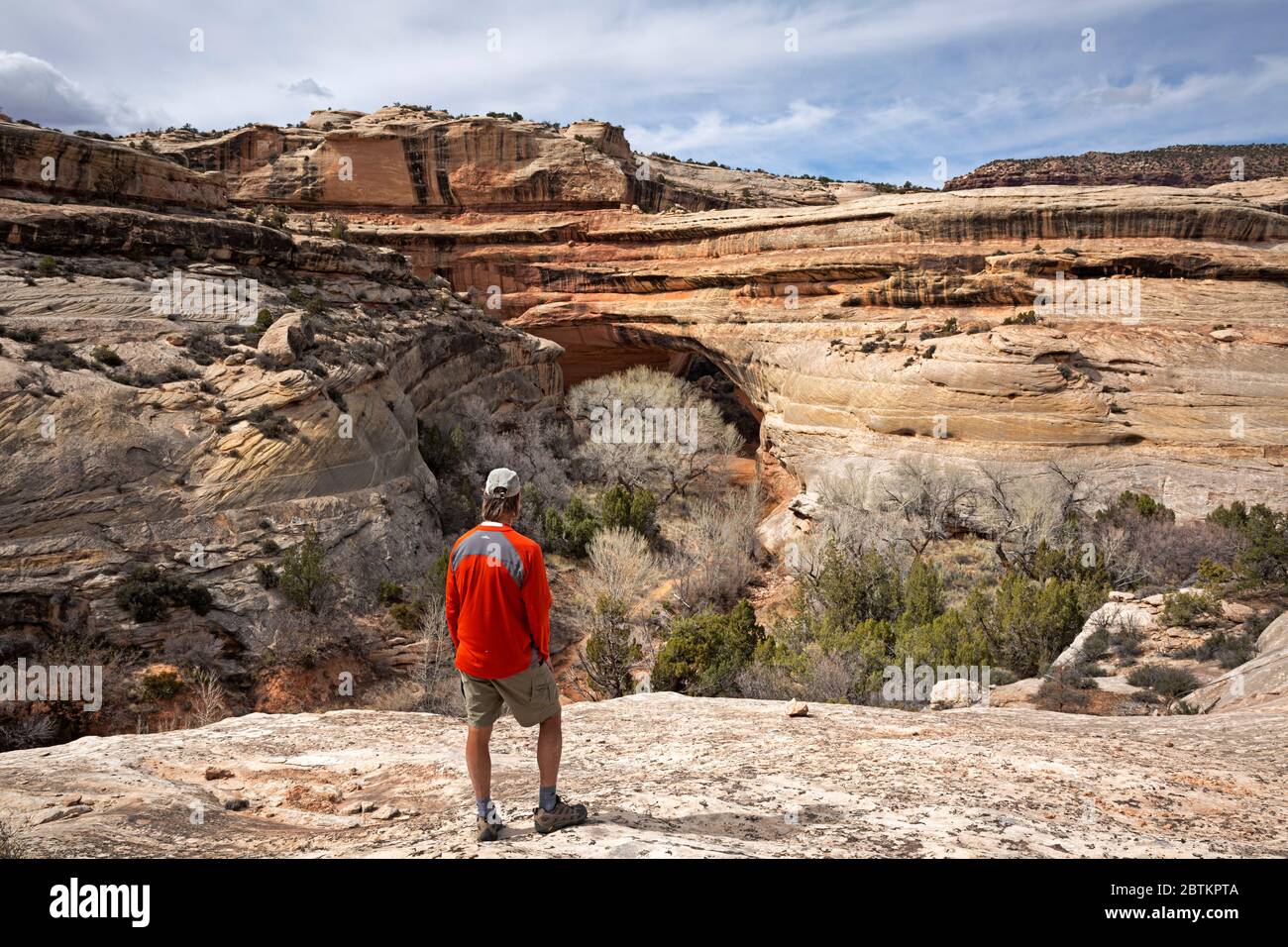 UT00669-00...UTAH - Hiker viewing the Kachina Bridge from the Kachina ...