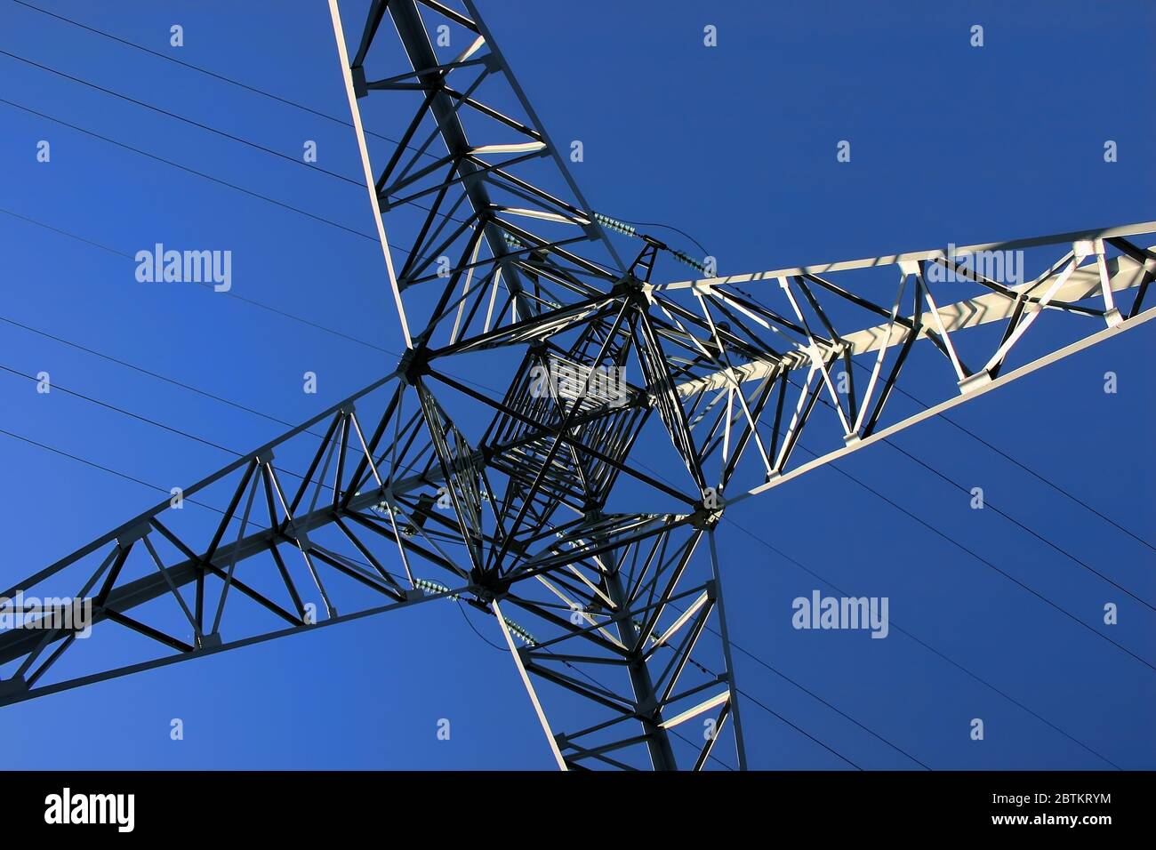 Detailed view of high voltage powerline tower construction, electric ...