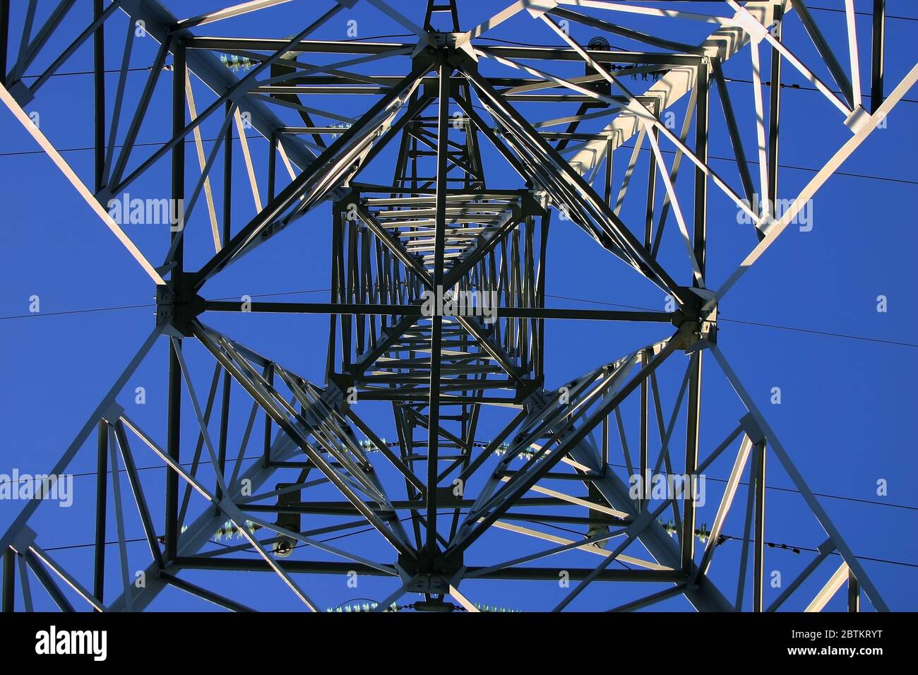 Detailed view of high voltage powerline tower construction, electric ...