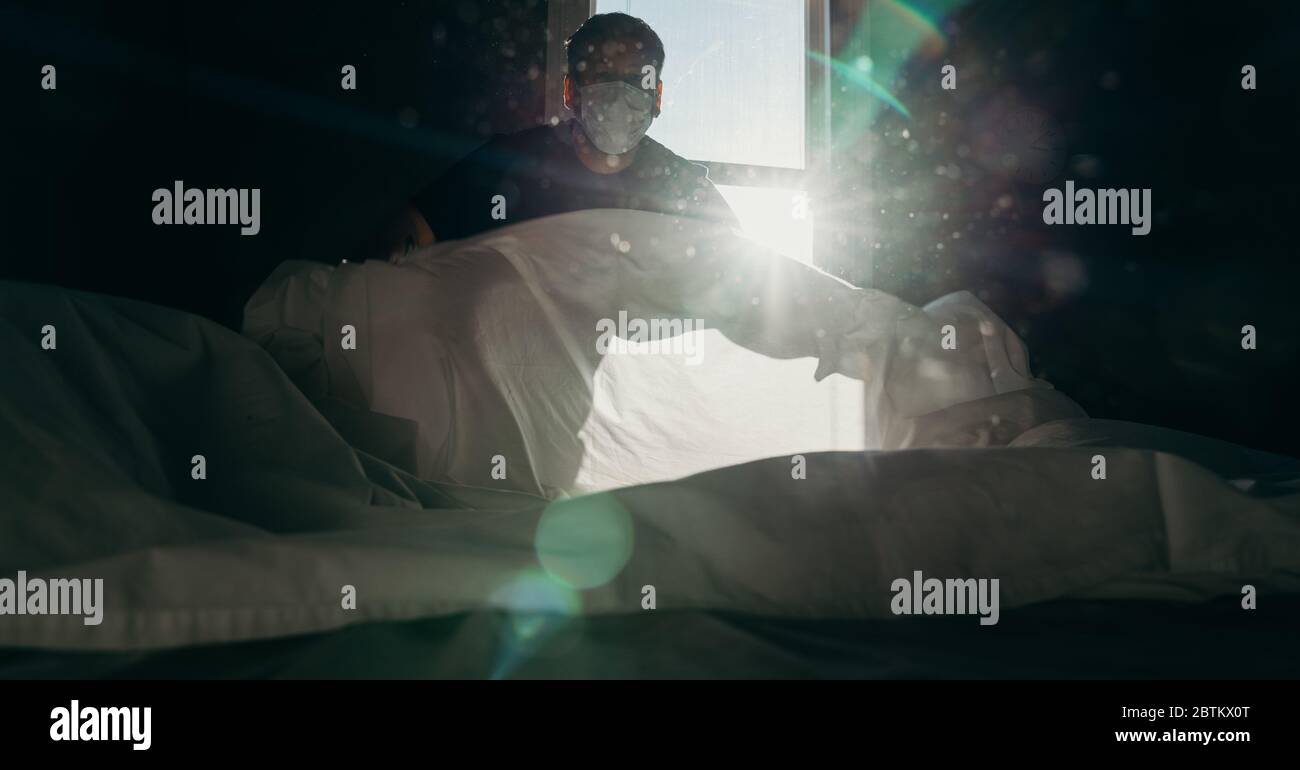 Asian man cleaning bed in morning. House keeping action. Bedroom gainst ...