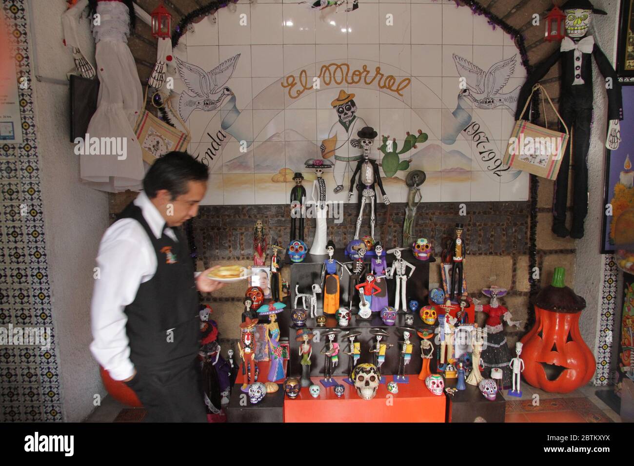 Waiter with Day of the Dead offering Stock Photo - Alamy