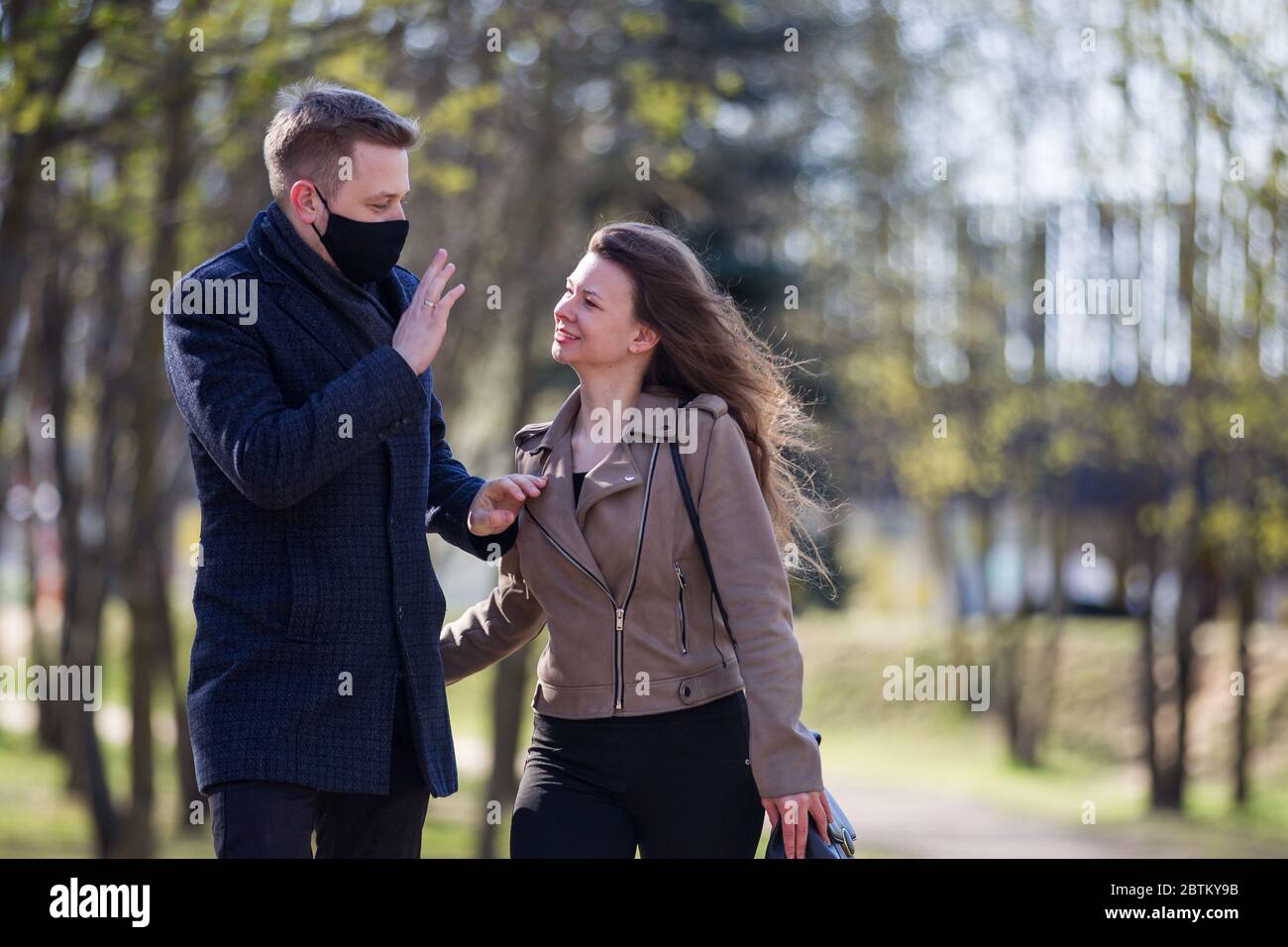 Couple walking in park protective hi-res stock photography and images ...