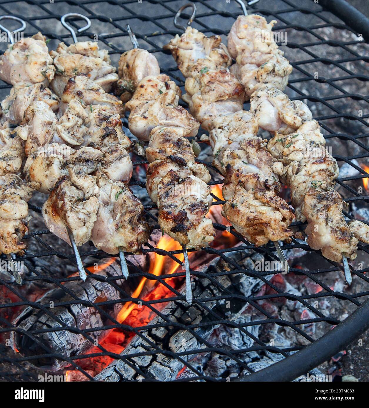 Healthy chicken kebab. Barbecue chicken meat on skewers outdoor. View ...
