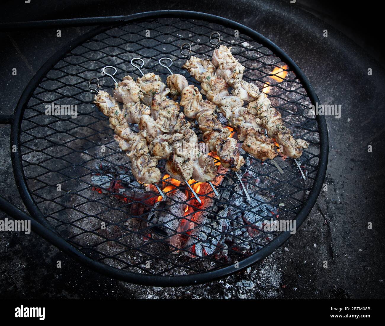 Healthy chicken kebab. Barbecue chicken meat on skewers outdoor. View ...