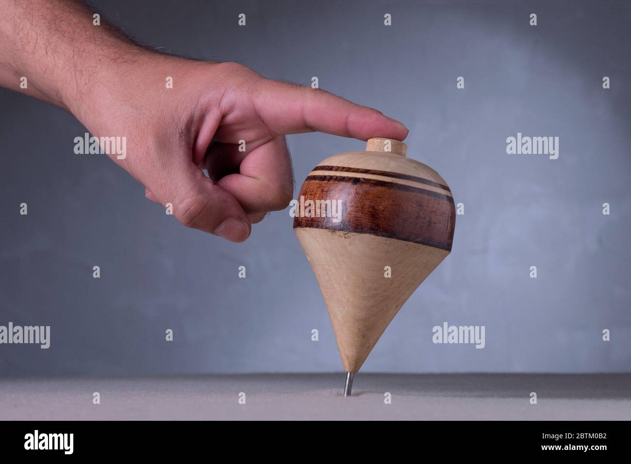 Small toy that spins on a person's hand demonstrating great skill and ...