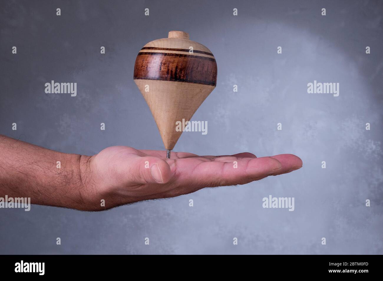 Small toy that spins on a person's hand demonstrating great skill and ...