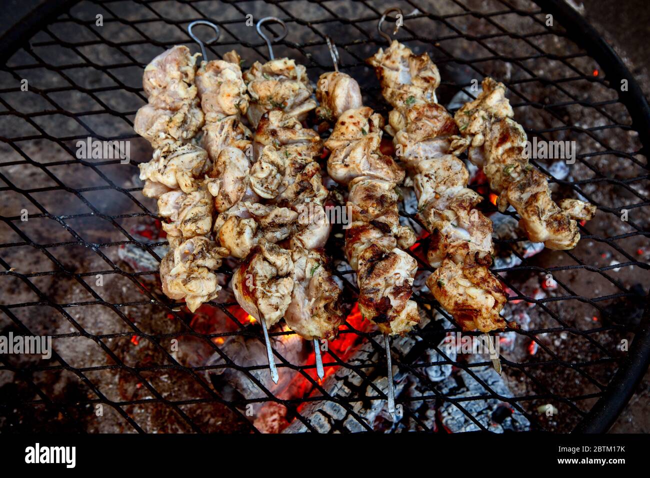 Healthy chicken kebab. Barbecue chicken meat on skewers outdoor. View ...