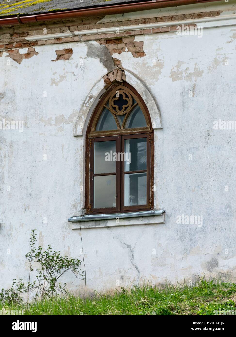 a photograph with arched windows on a white church wall Stock Photo - Alamy