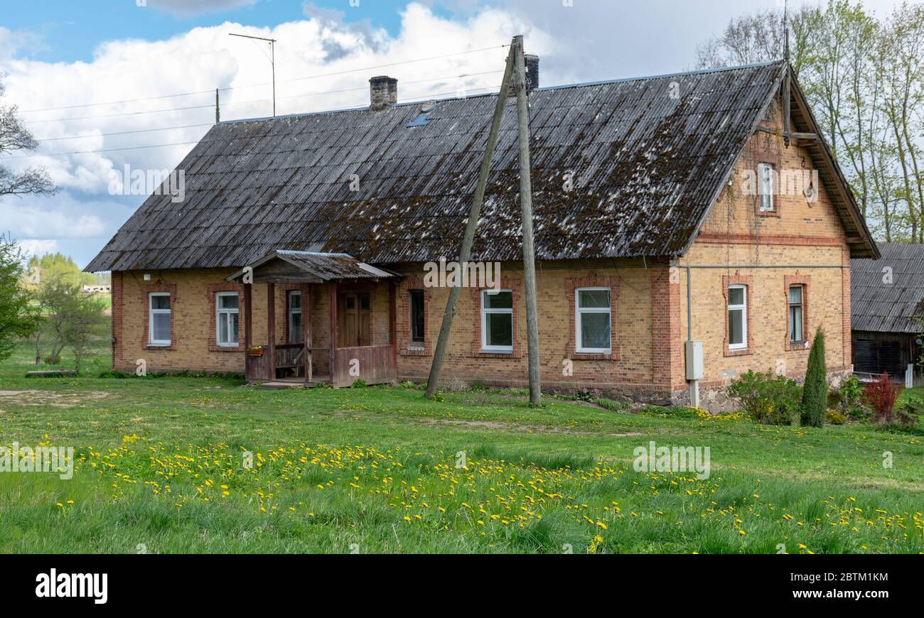 landscape with a traditional and simple country house, beautiful spring ...