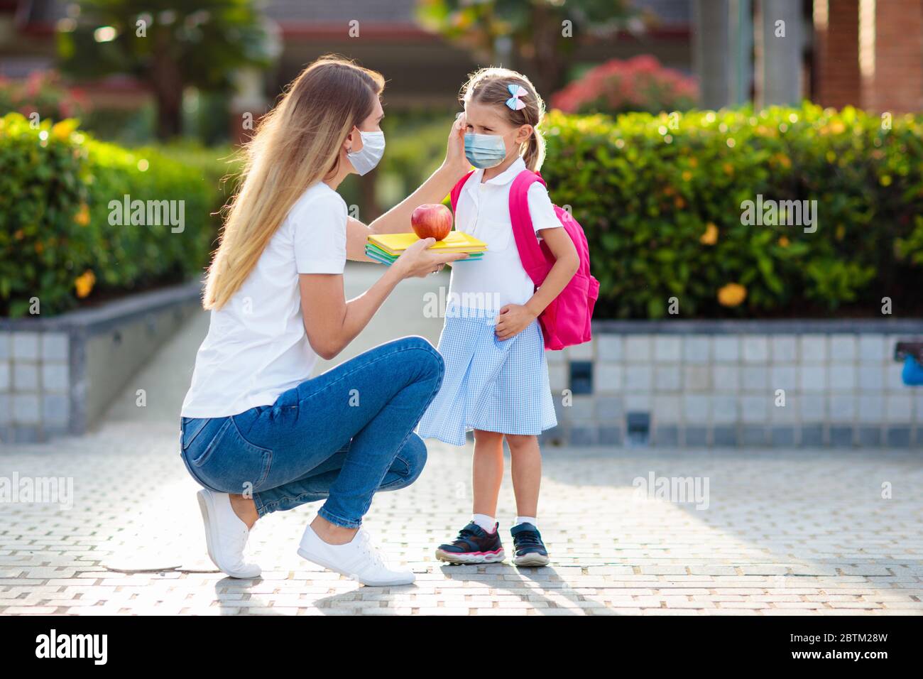 Mother and child wearing face mask going to school during coronavirus ...