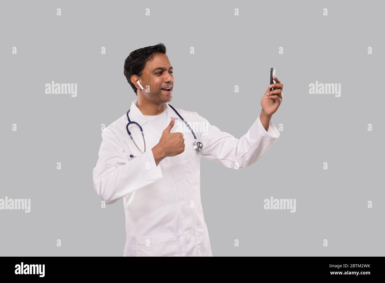 Doctor Having Video Call on Phone Showing Thumb Up with Wireless ...