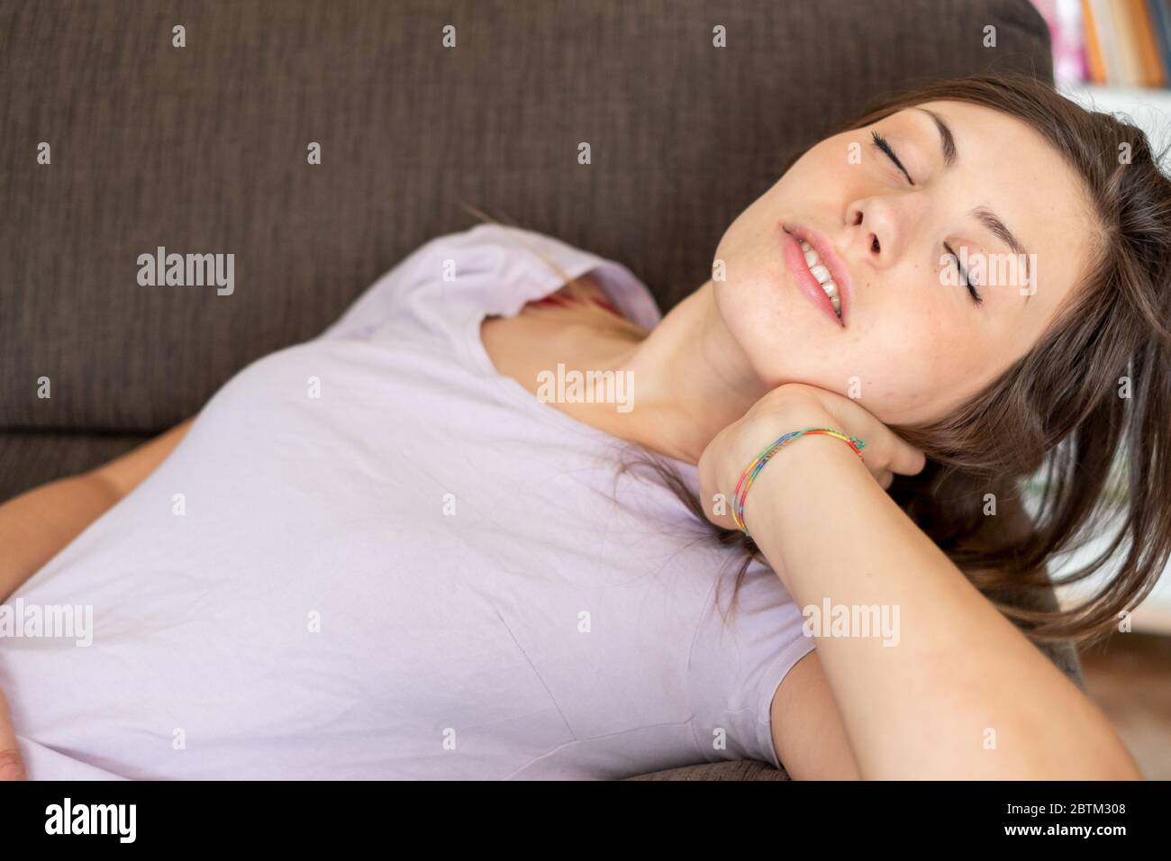 Young woman sleeping on a couch hi-res stock photography and images - Alamy