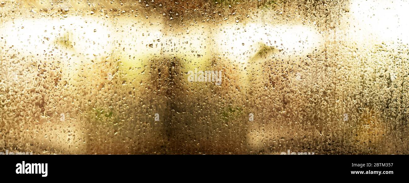 surface of wet gold metal with drop of water glowing by reflection ...