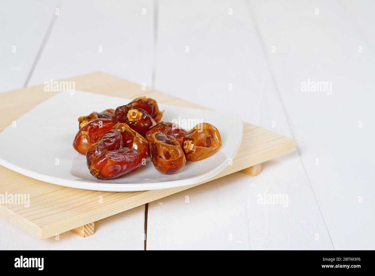 Sweet dates on white plate Stock Photo - Alamy