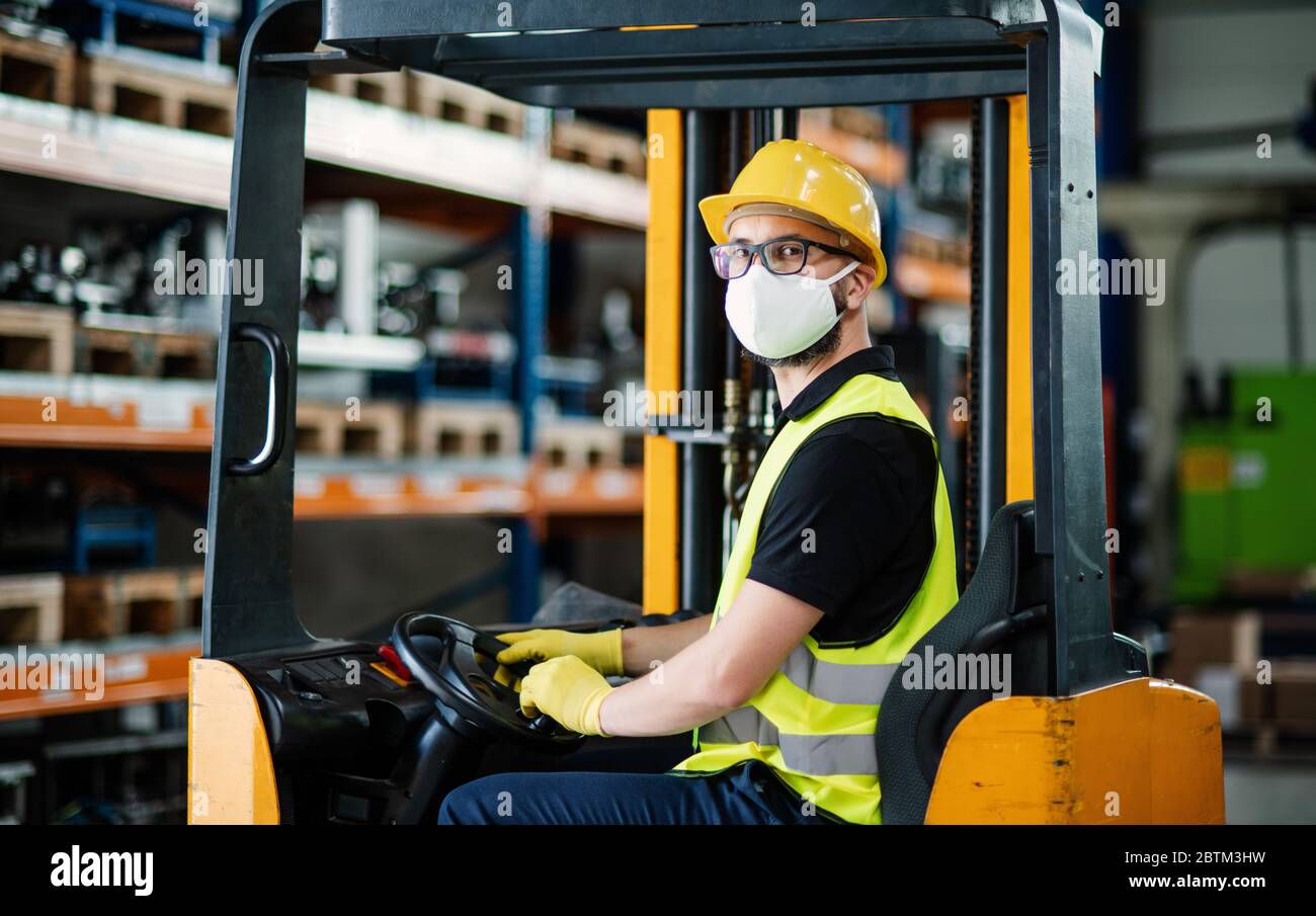 Worker helmet driving forklift hi-res stock photography and images - Alamy