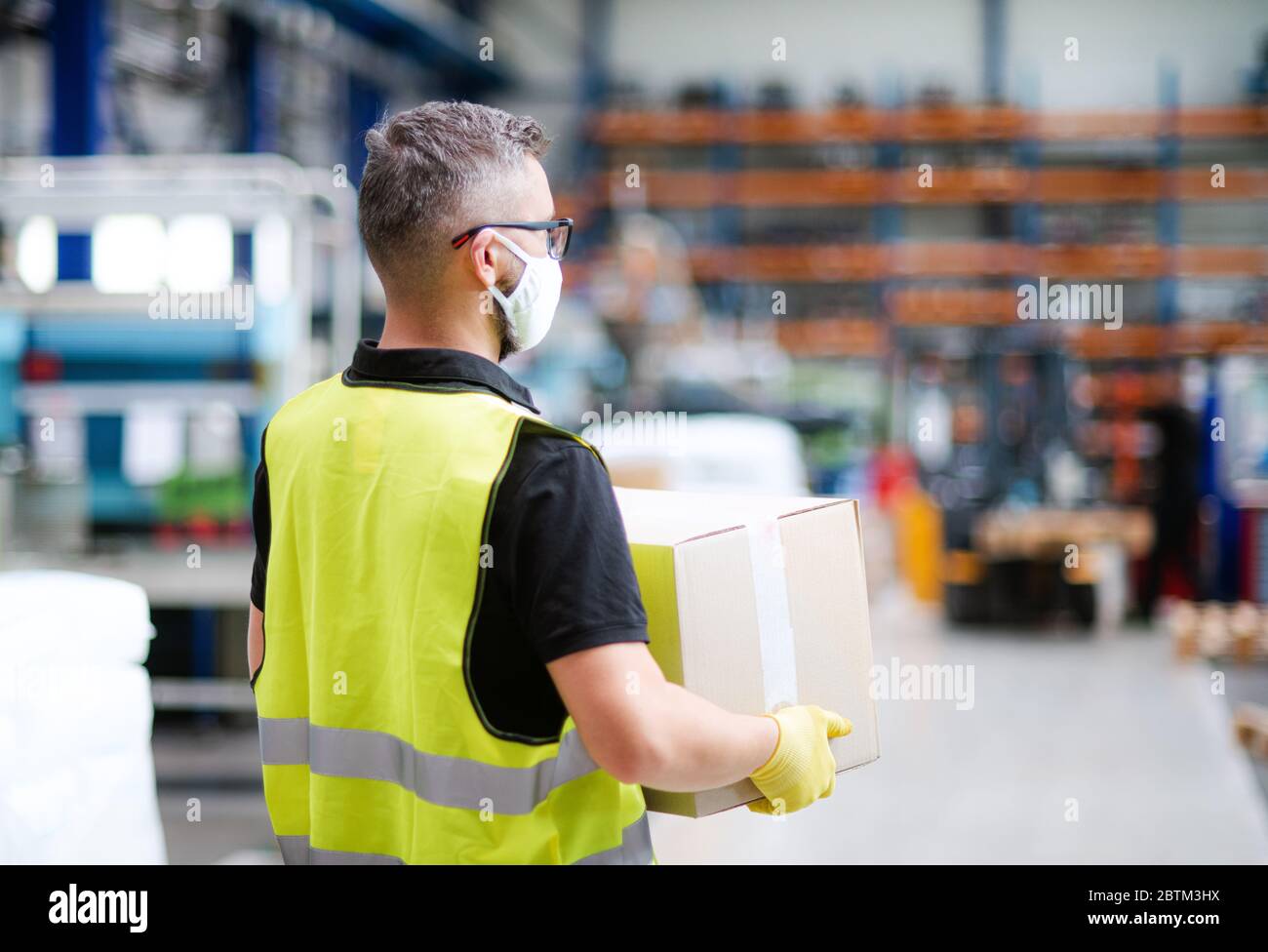 Factory worker wearing gloves hi-res stock photography and images - Alamy