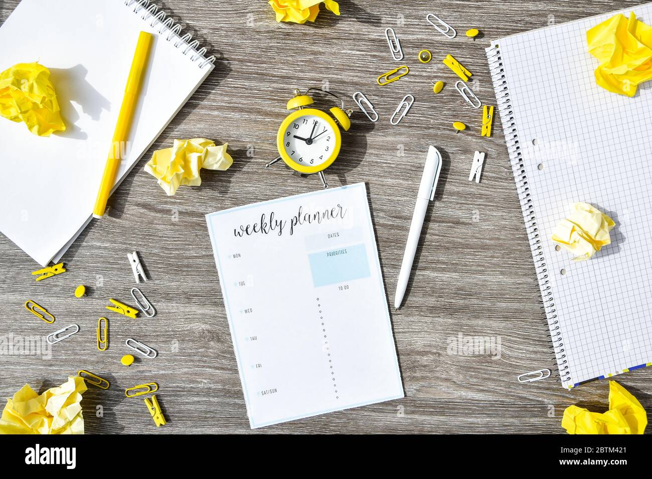 Weekly planner with alarm clock and office supplies. Business planning ...