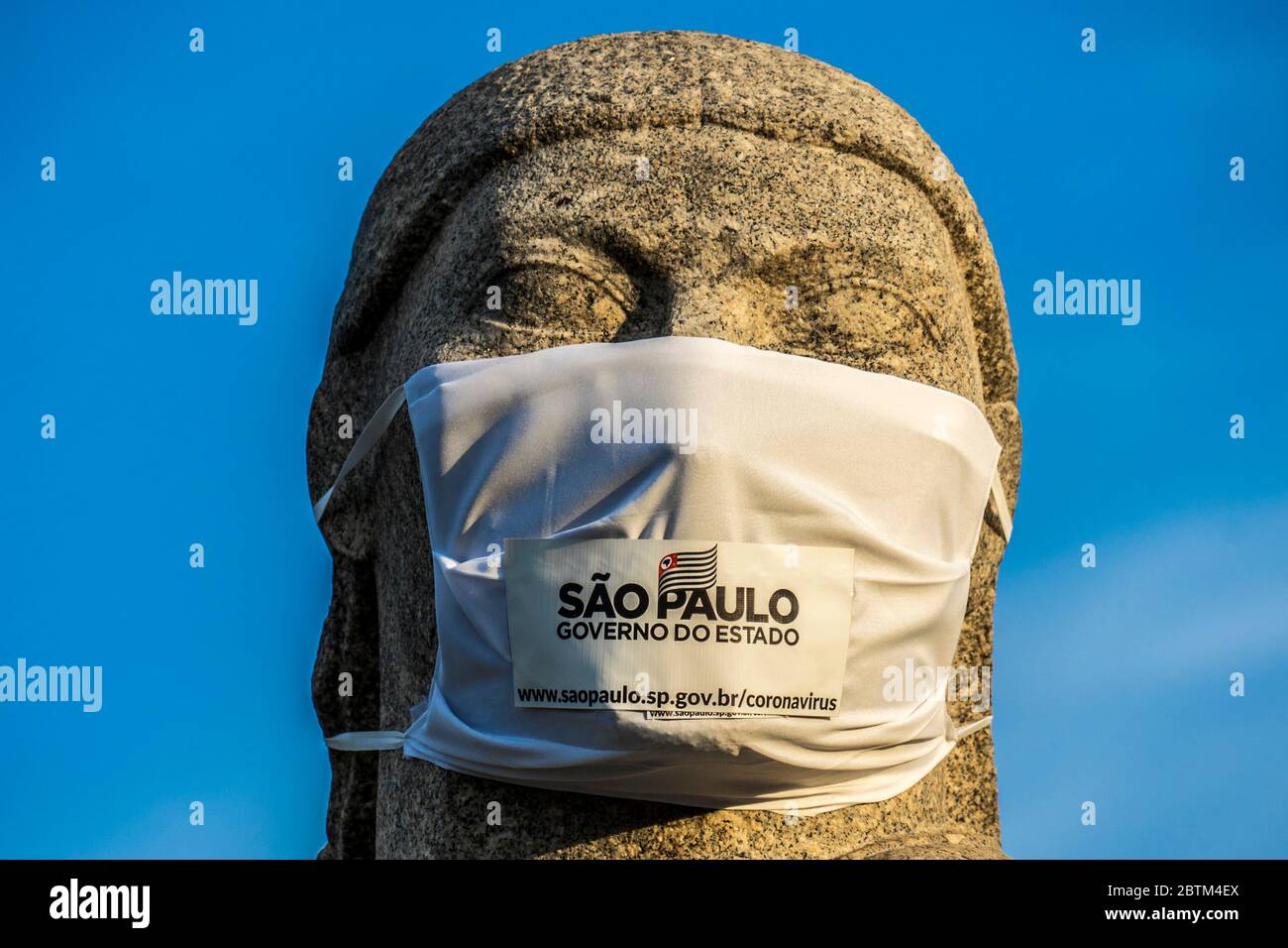 View of the Monument to the Banderias adorned with protective mask ...