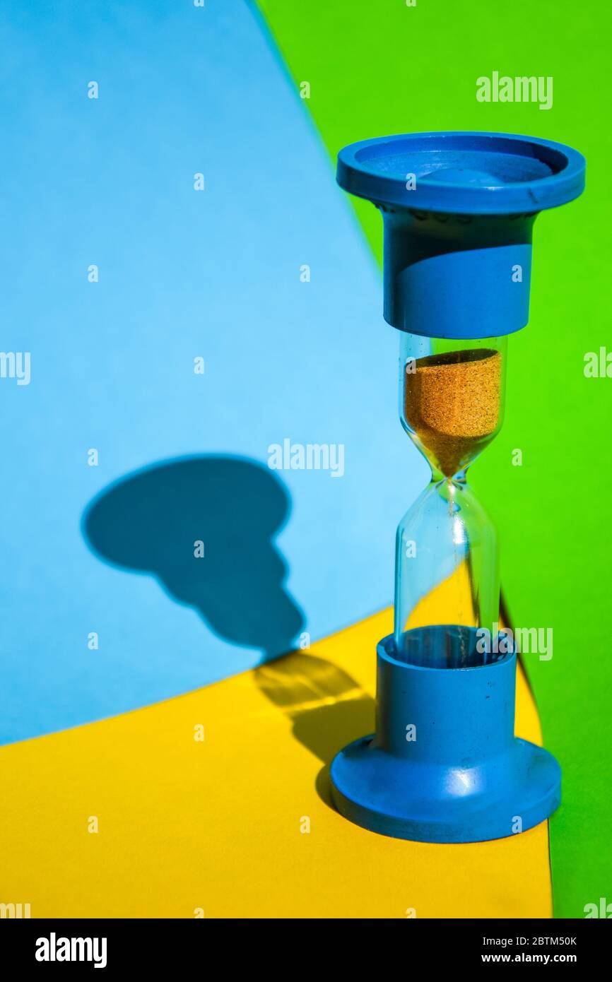 Hourglass colored background, copy space for text, Hourglass shows that ...