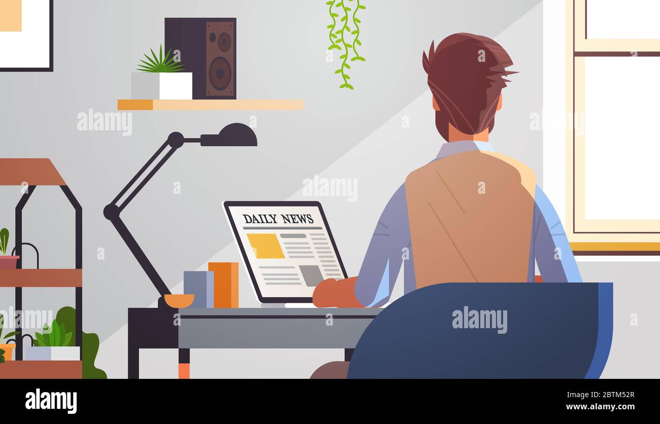 businessman sitting at workplace reading daily news articles on laptop ...