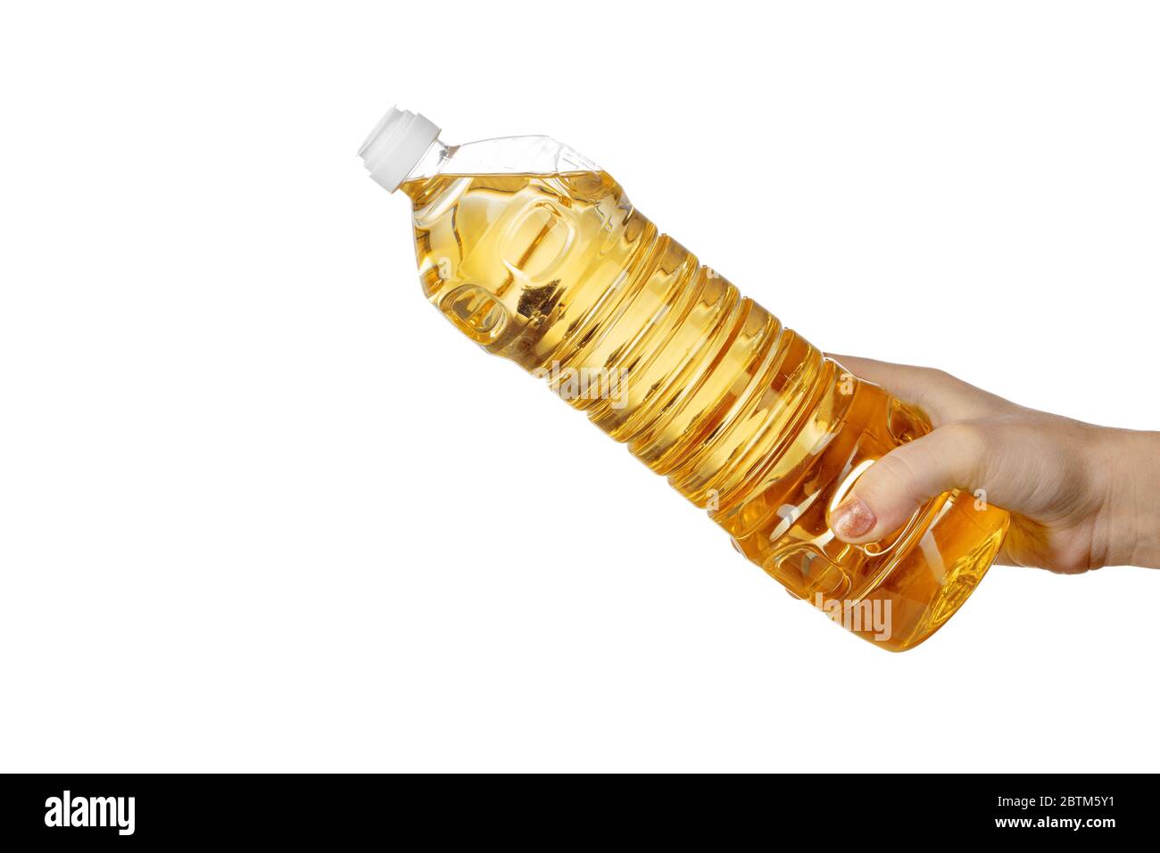 Hand of woman pouring cooking oil from plastic bottle. Isolated on ...
