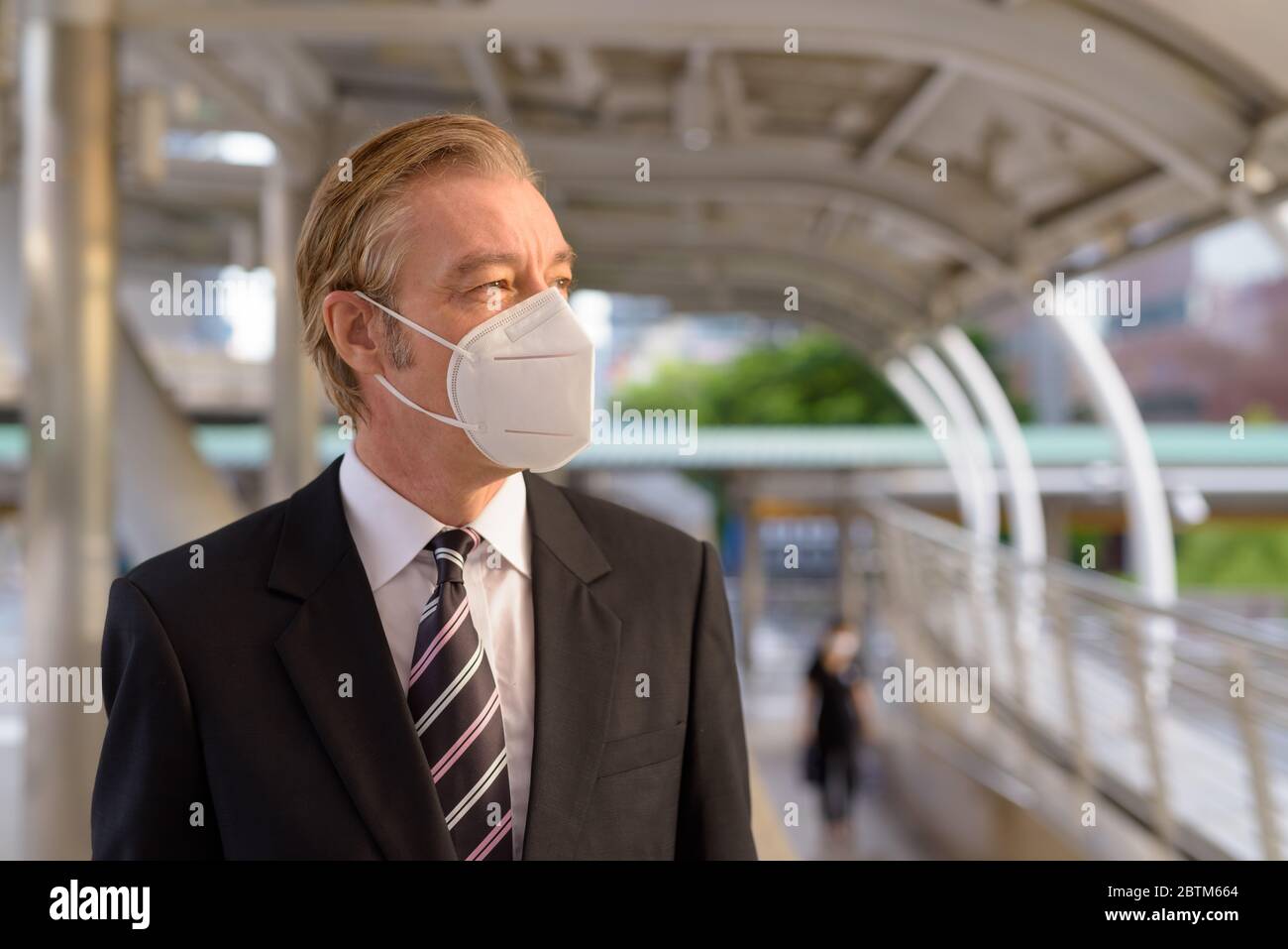 Face of mature businessman with mask for protection from corona virus ...