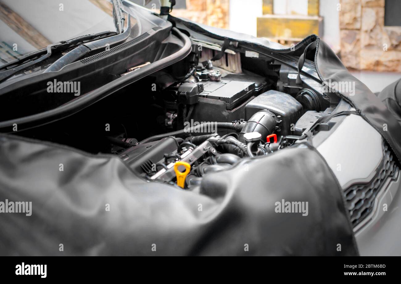 Car with opened hood and engine look on the garage Stock Photo - Alamy