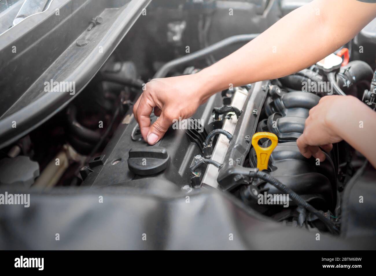 Car mechanic working on engine repair on the garage Stock Photo - Alamy