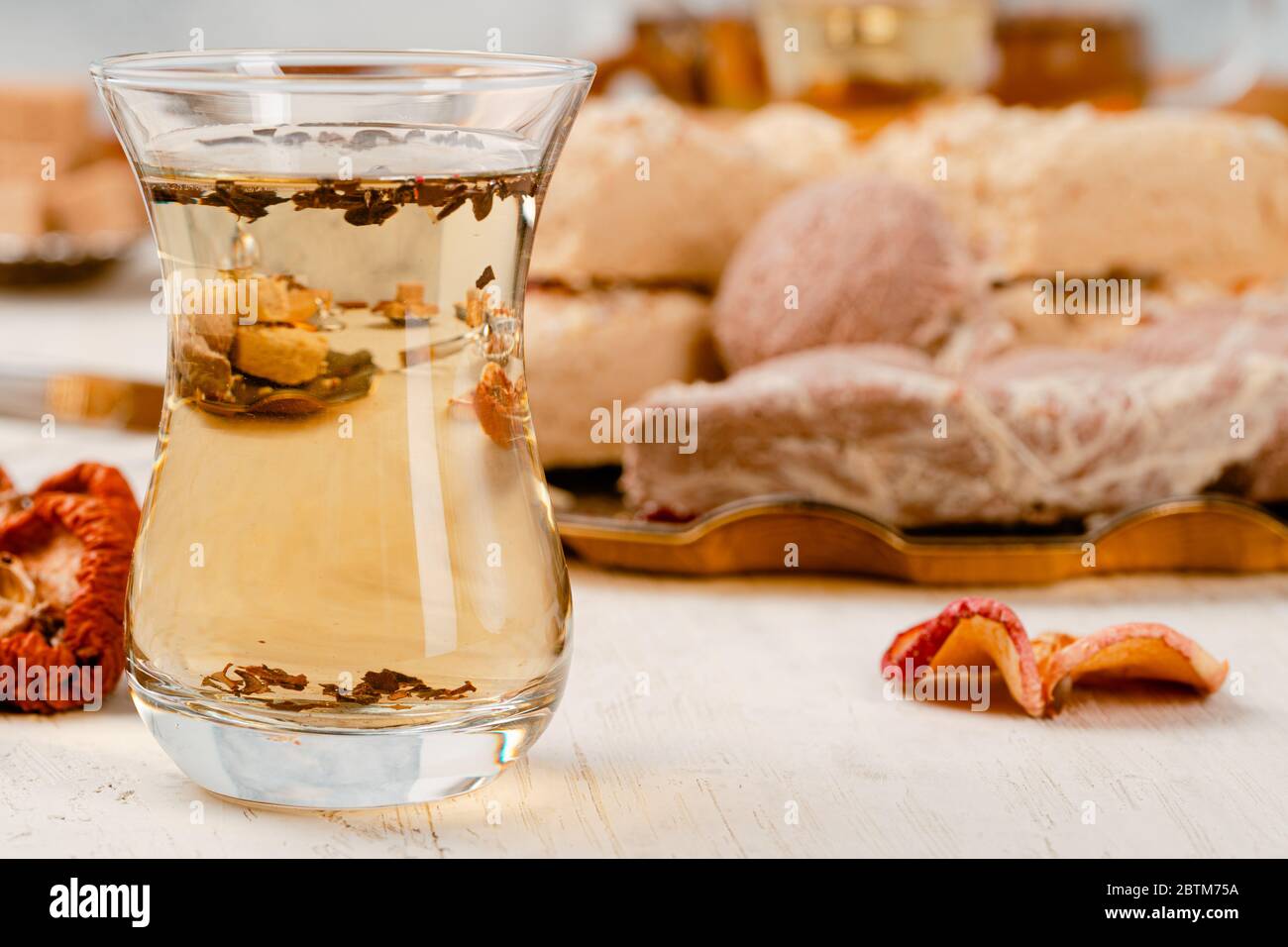 Turkish halva with tea in a glass cup close up Stock Photo - Alamy