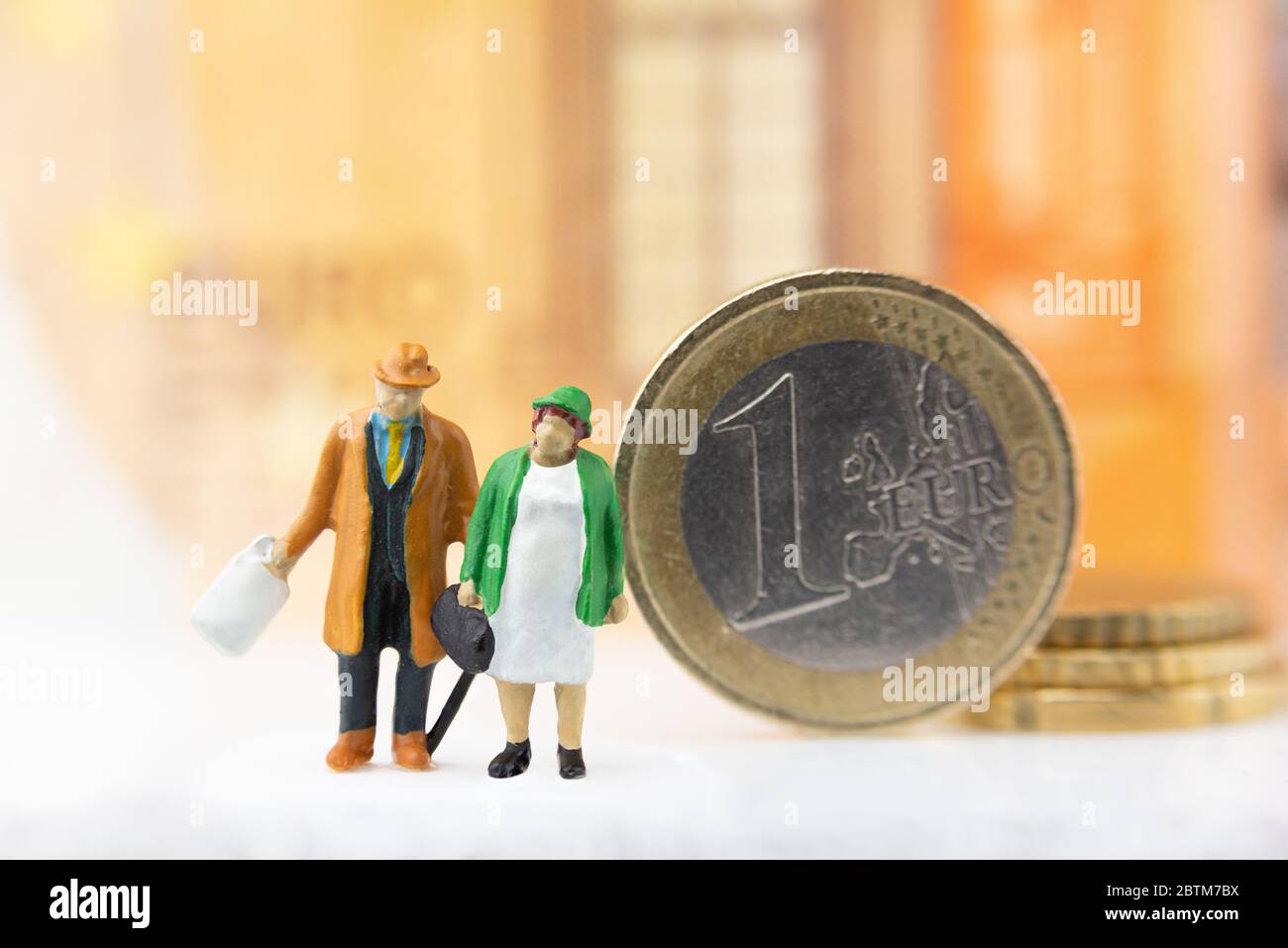 Miniature figures elderly people money hi-res stock photography and ...
