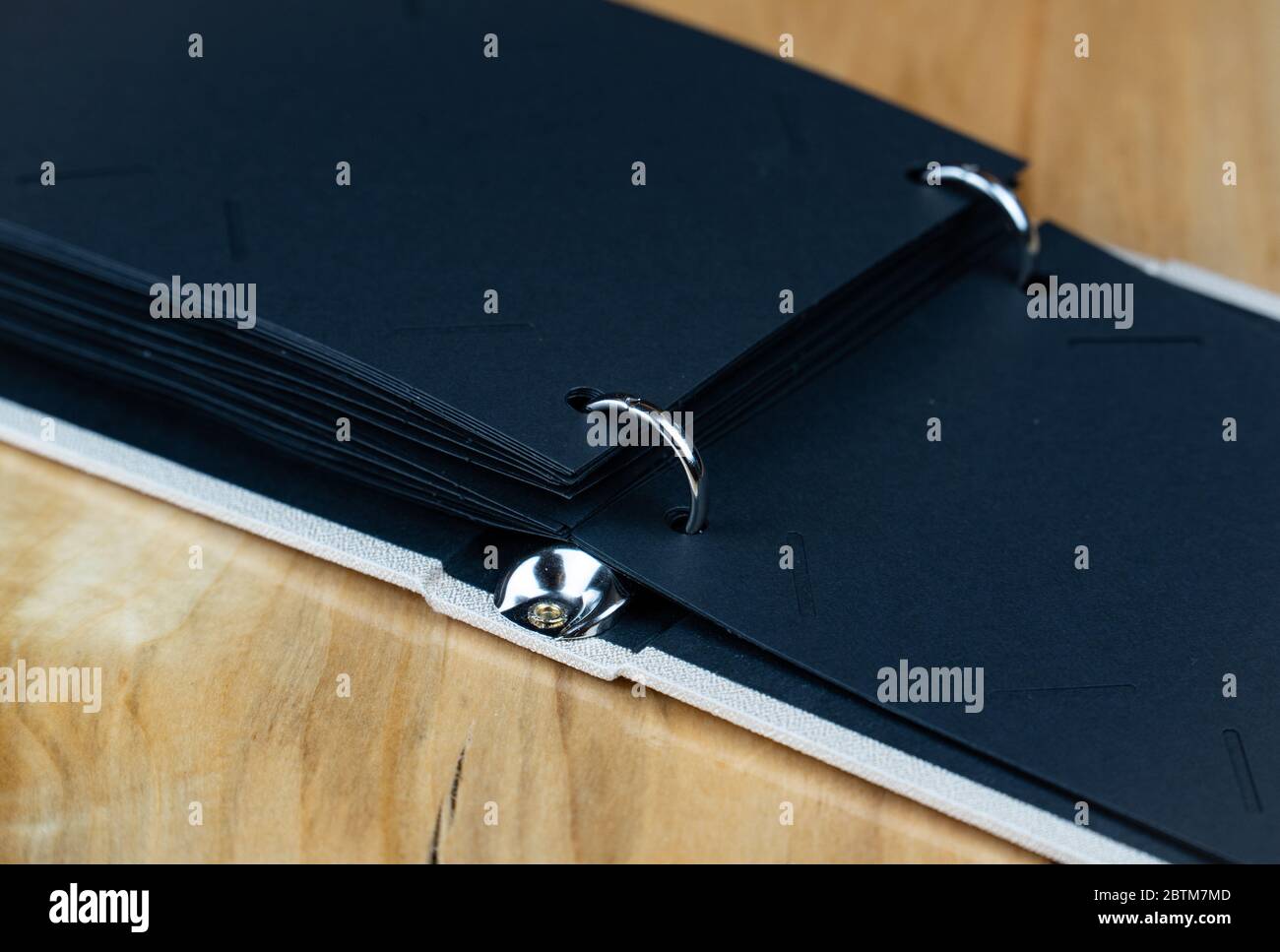 Striped album for a photo on a wooden table Stock Photo - Alamy
